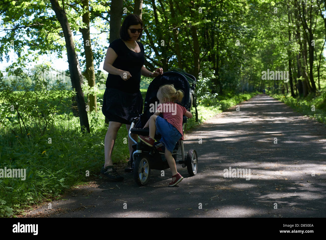 Baby pushing pram hi-res stock photography and images - Alamy