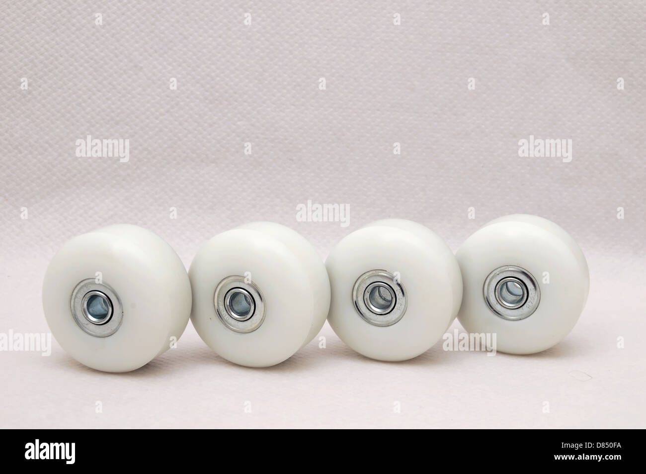 4 white Skate wheels on a clear background Stock Photo - Alamy