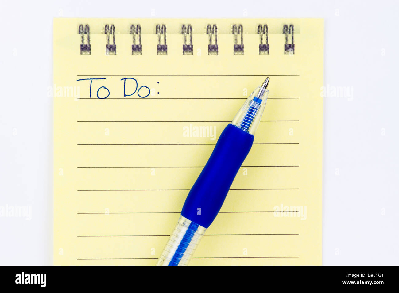 A close up of a sheet of lined yellow paper with To Do written on it ...