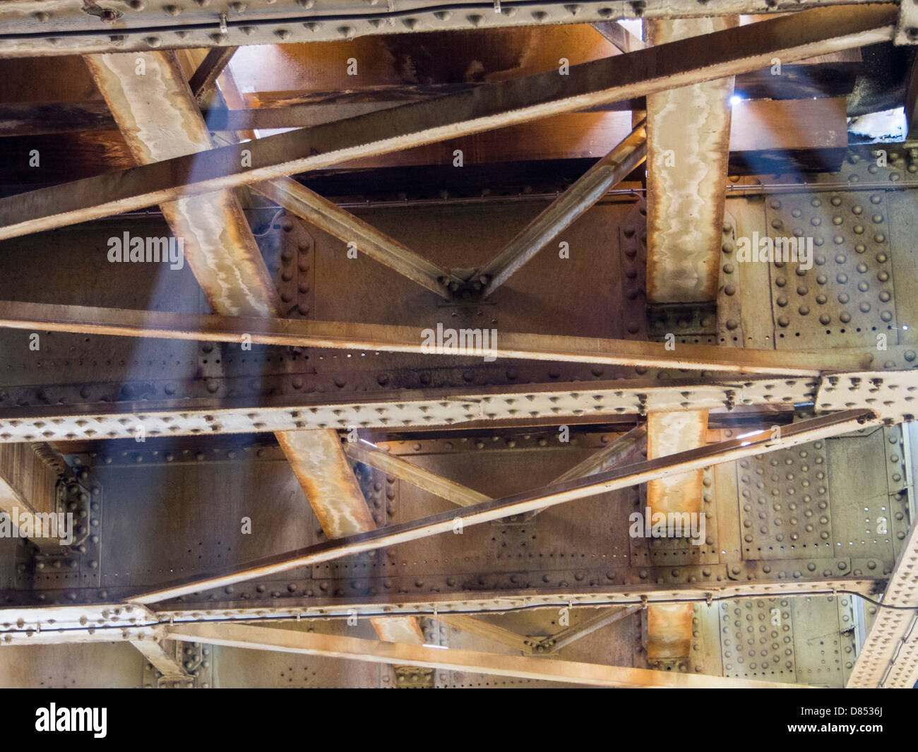 Shafts of light below railway tracks on a bridge in Amsterdam ...