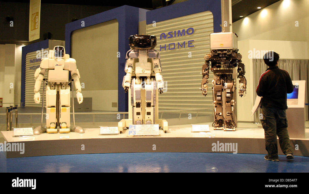 A Honda prototype robot interacts with a child, showcasing the ...