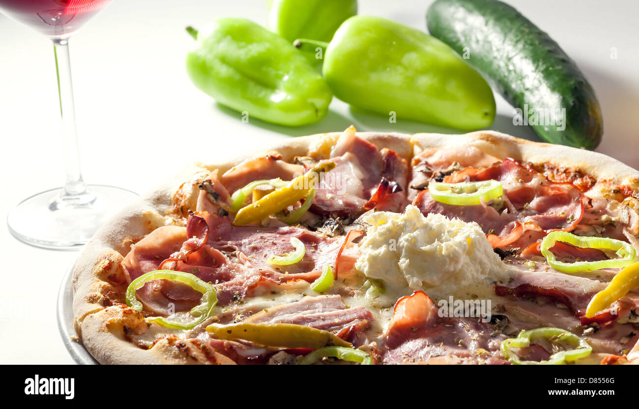 Pizza with ham, milk cream and peppers Stock Photo - Alamy