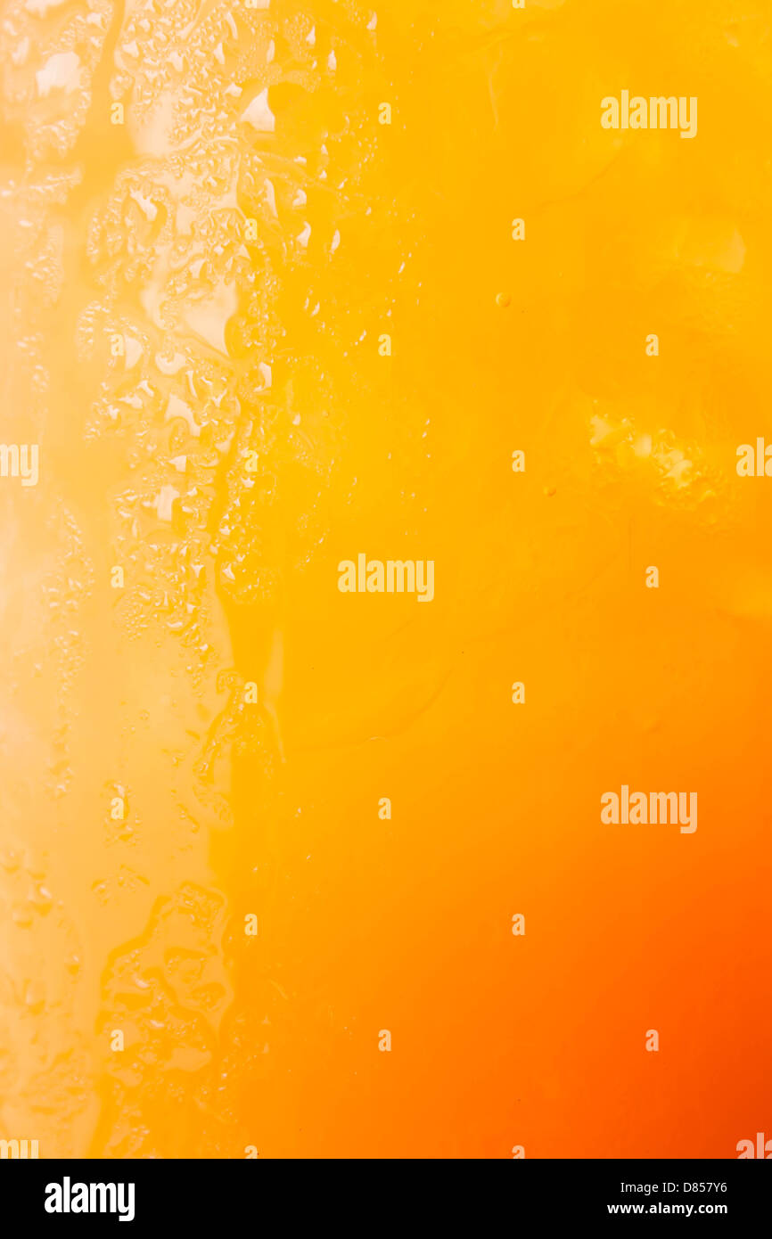 Fizzy glass of iced orange juice up close Stock Photo - Alamy