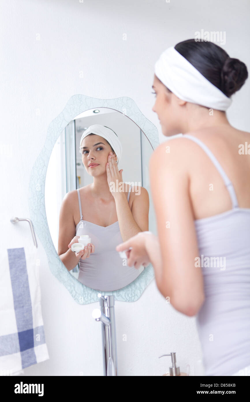 young woman applying face cream Stock Photo - Alamy