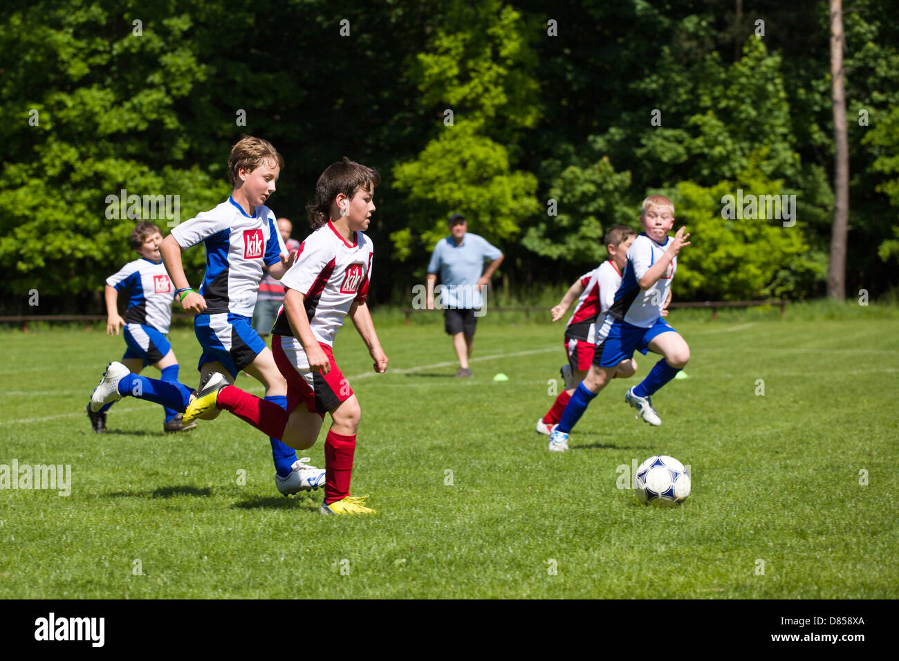 Little Boys playing soccer match Stock Photo - Alamy