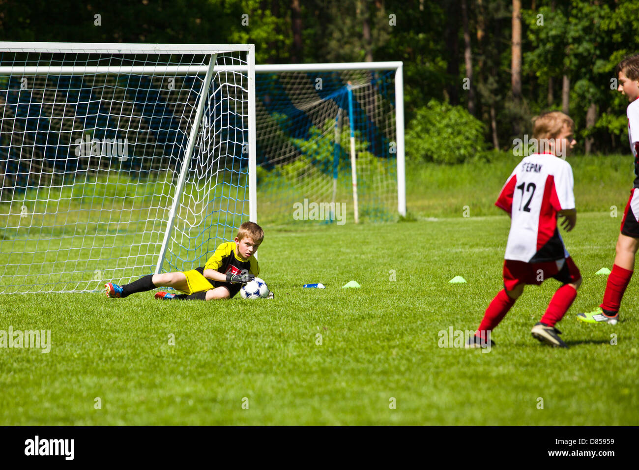 Little Boys playing soccer match Stock Photo - Alamy