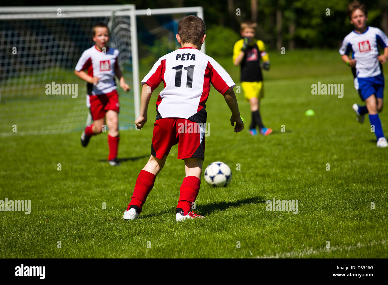 Little Boys playing soccer match Stock Photo - Alamy