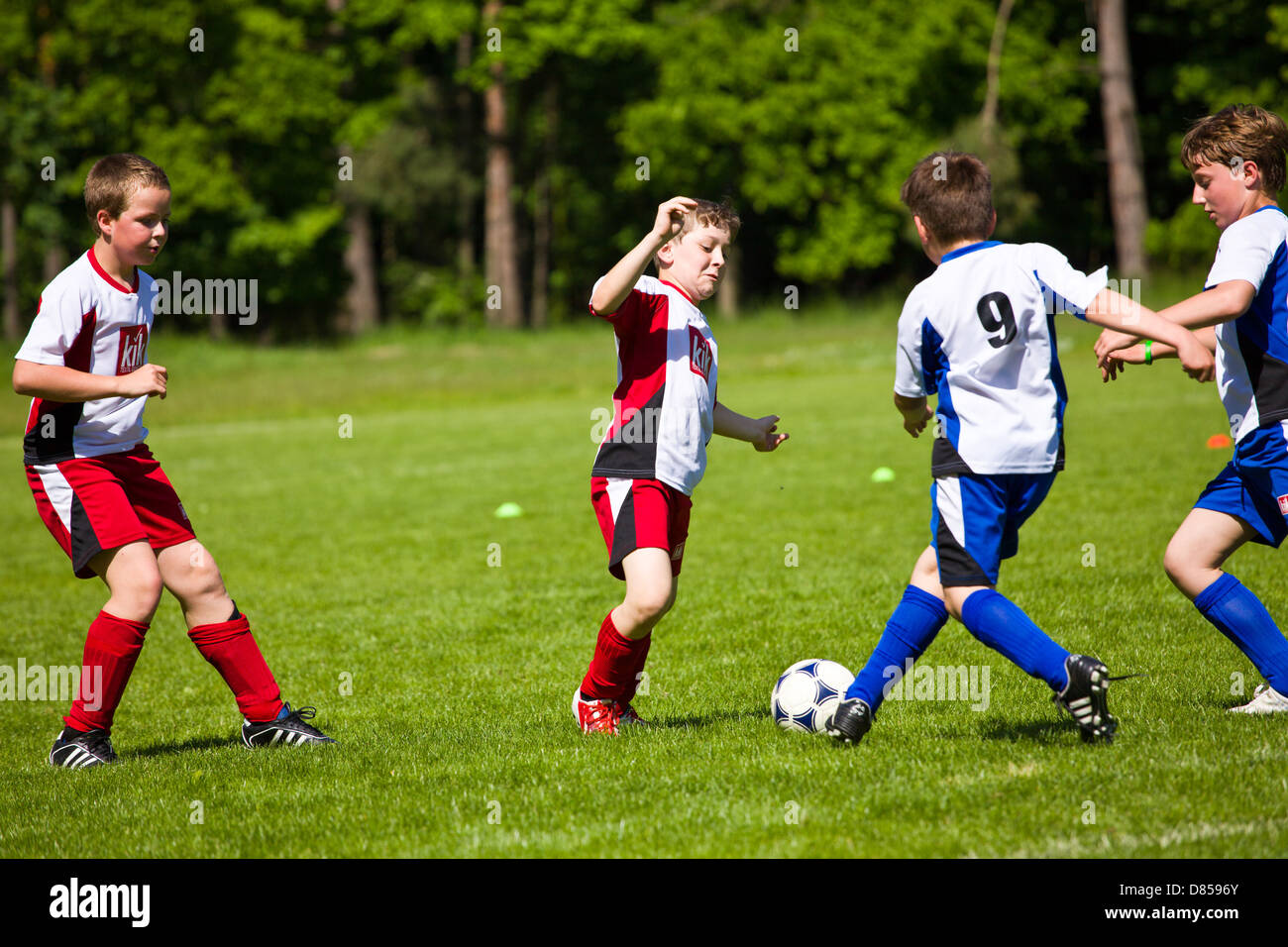 Little Boys playing soccer match Stock Photo - Alamy