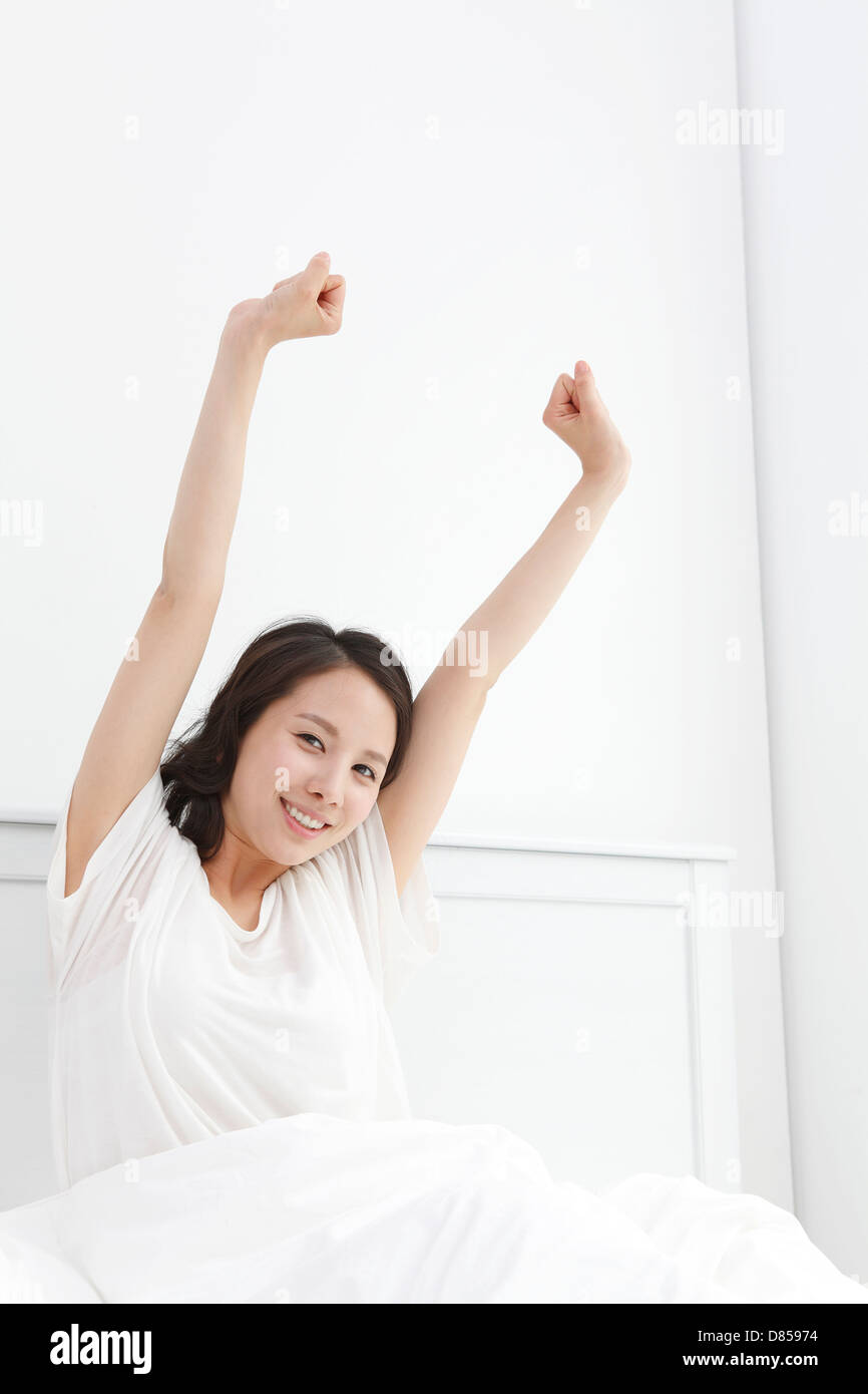 young woman stretching in bed Stock Photo - Alamy