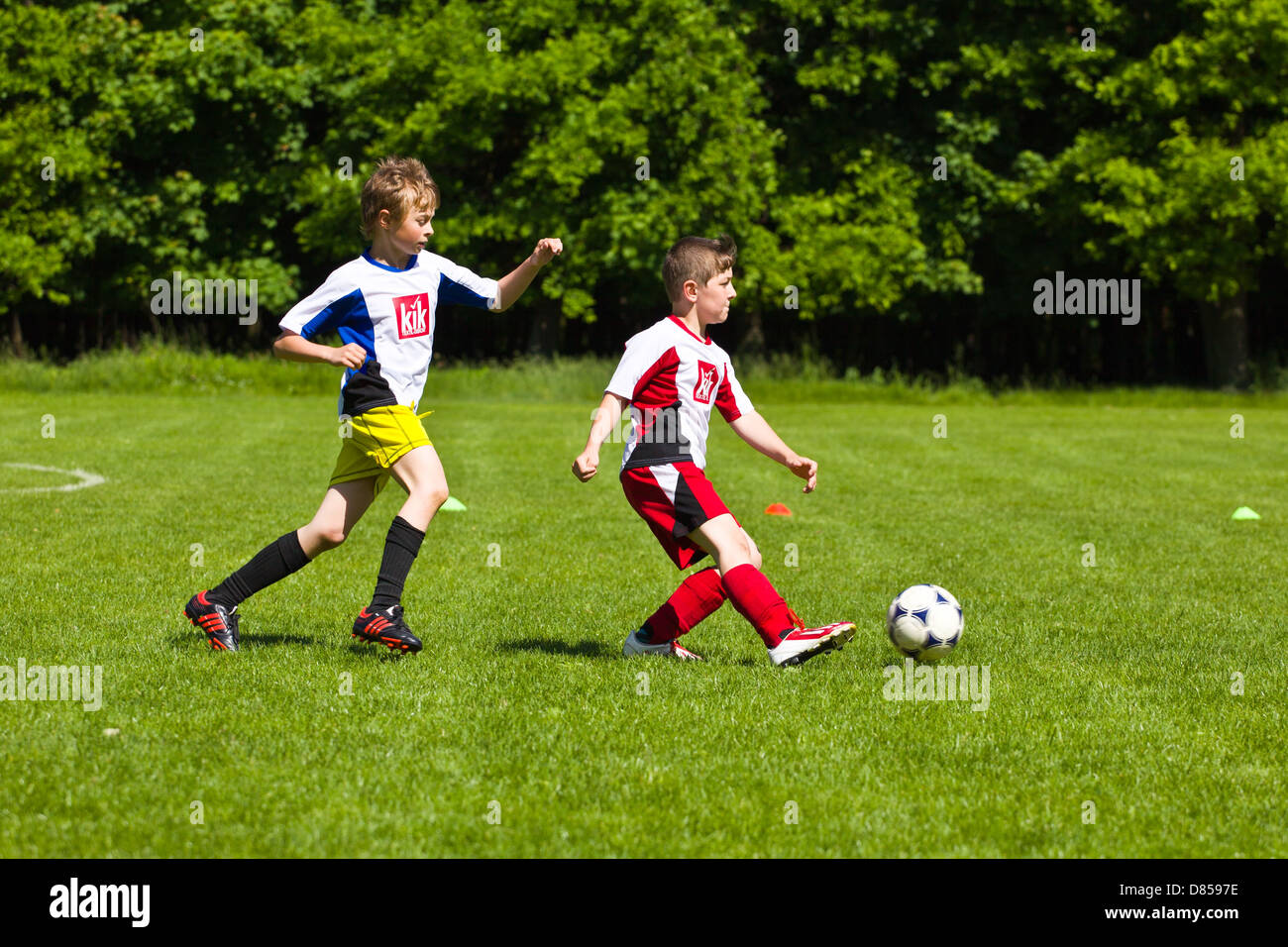 Little Boys playing soccer match Stock Photo - Alamy