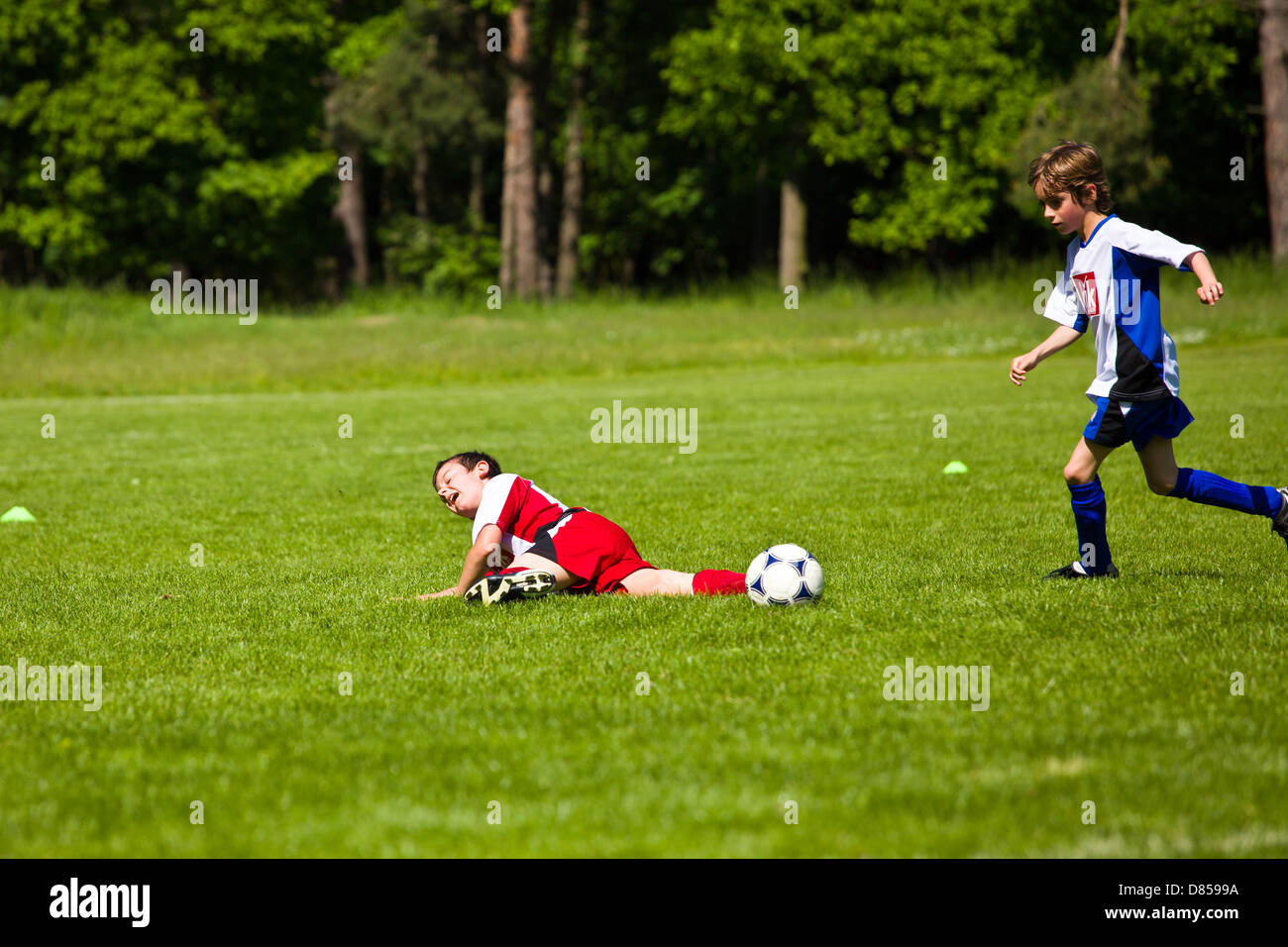 Little Boys playing soccer match Stock Photo - Alamy