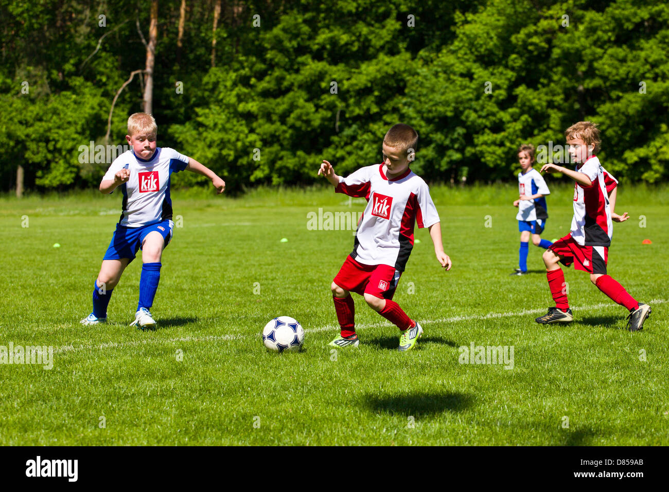Little Boys playing soccer match Stock Photo - Alamy