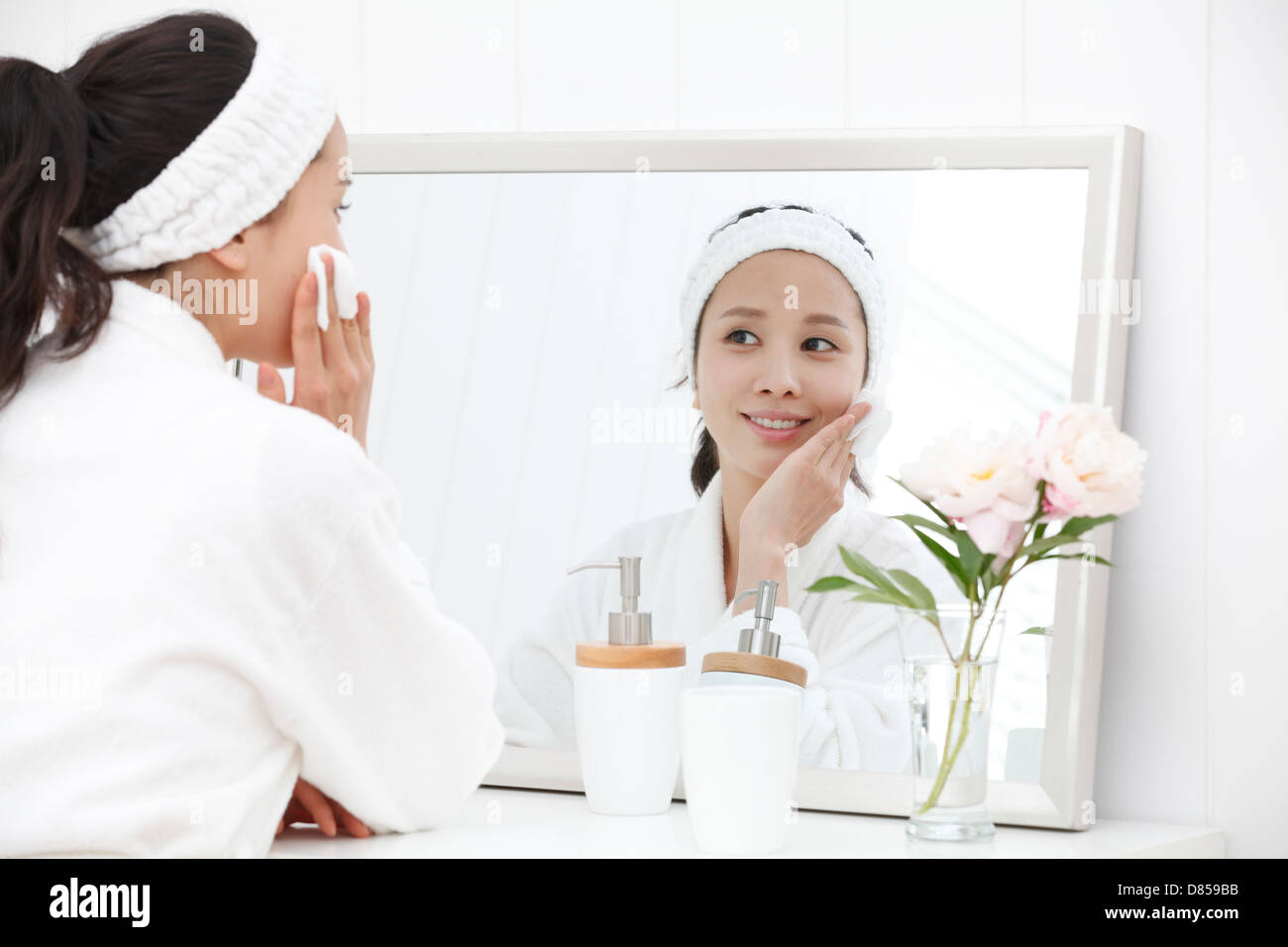 young woman applying face cream Stock Photo - Alamy