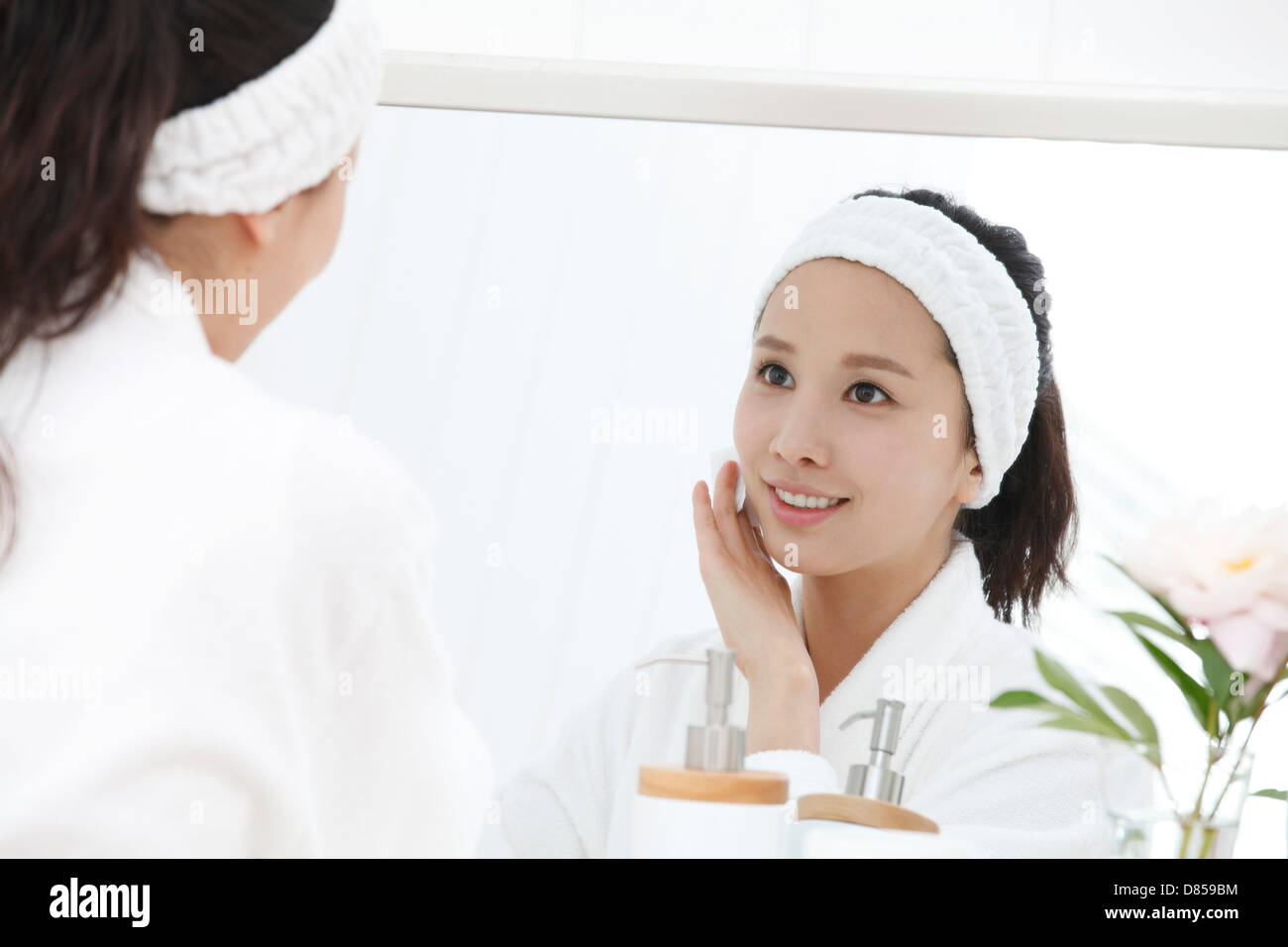 young woman applying face cream Stock Photo - Alamy