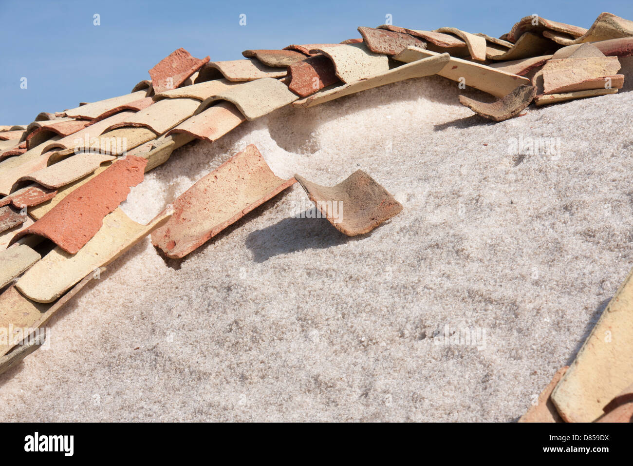 Roof Tiles on a salt hill, broken and tiles washed away by rain the ...