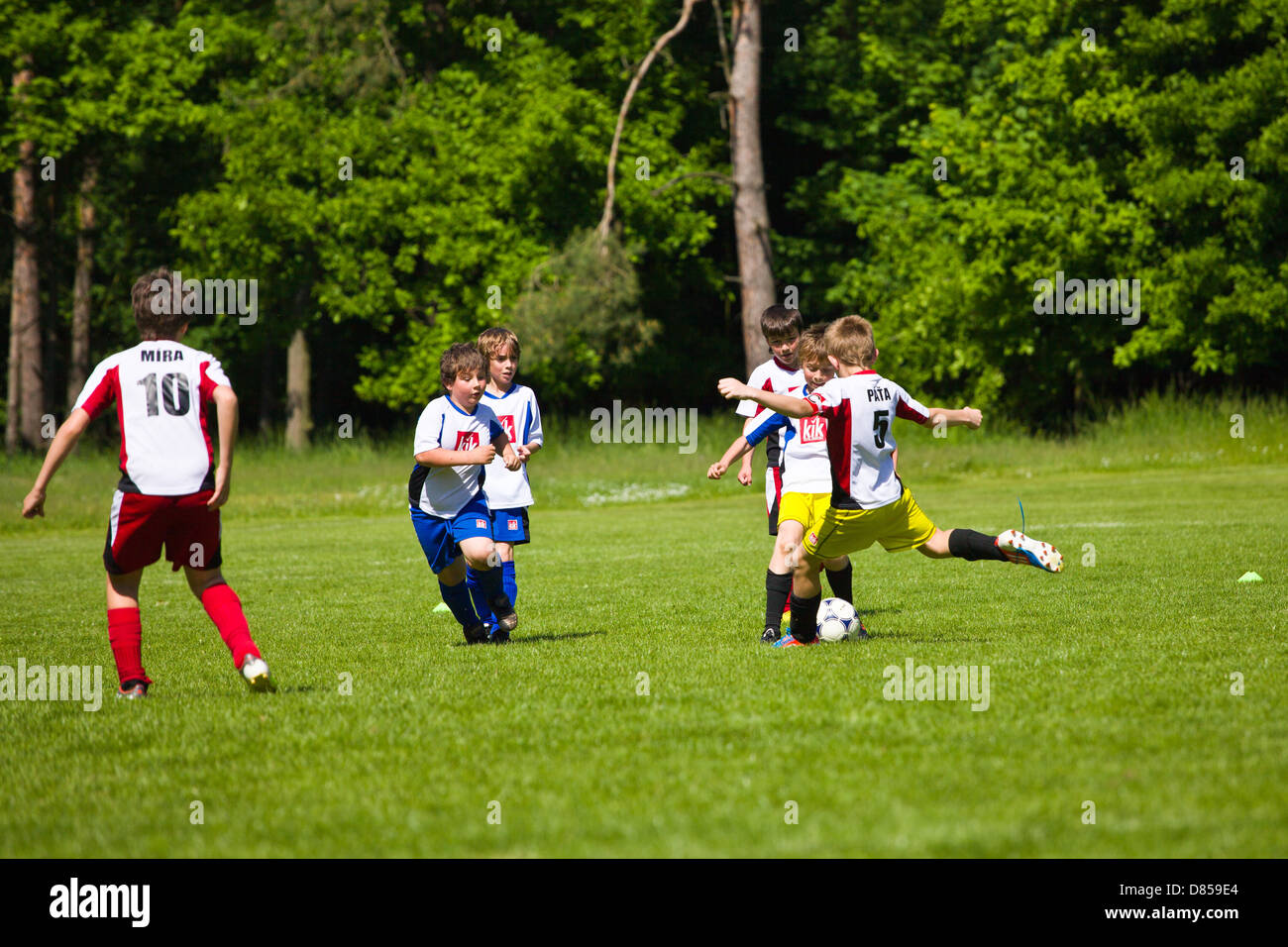 Little Boys playing soccer match Stock Photo - Alamy