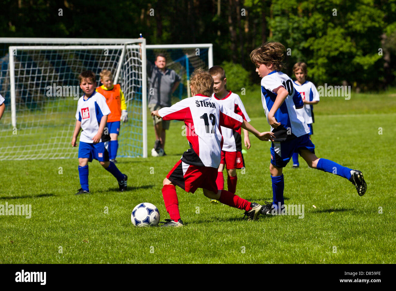 Little Boys playing soccer match Stock Photo - Alamy