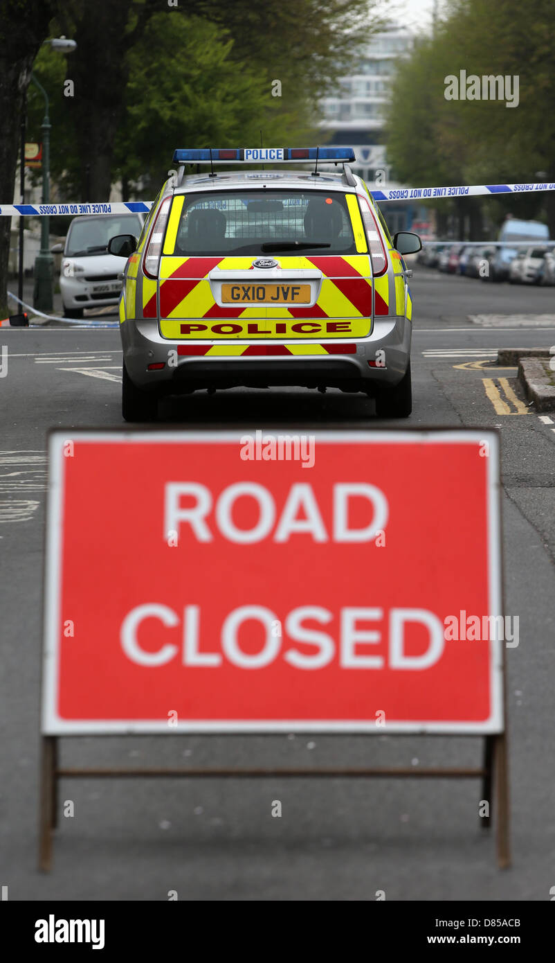 Road Closed traffic sign and a police car at a crime scene. Picture by ...