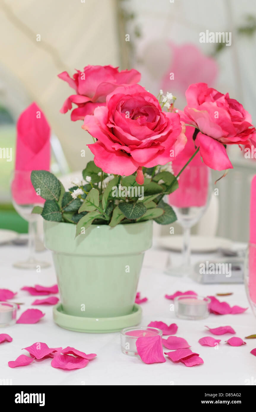 Pink roses decorate a table at wedding reception Stock Photo - Alamy