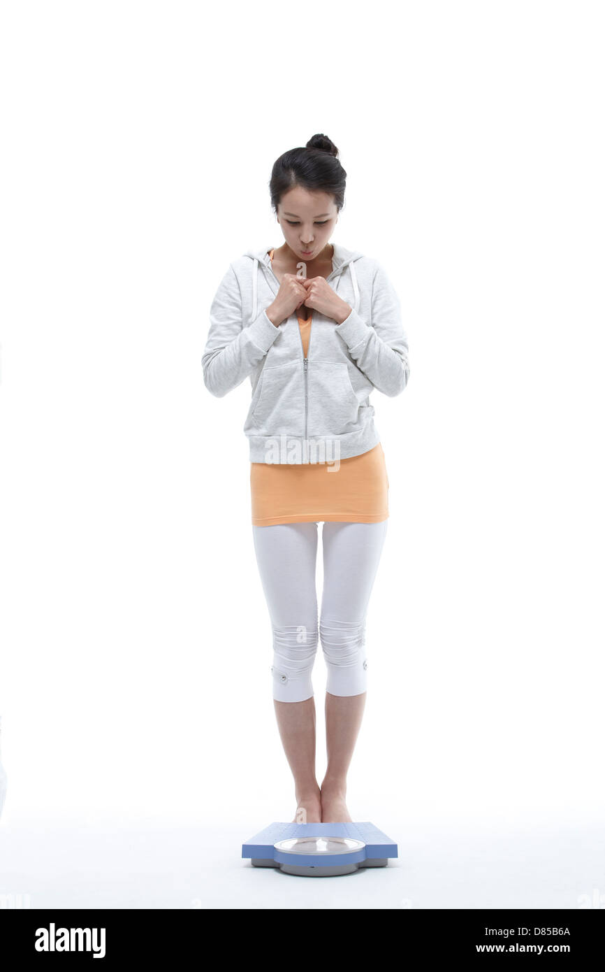 young woman posing on scales Stock Photo - Alamy