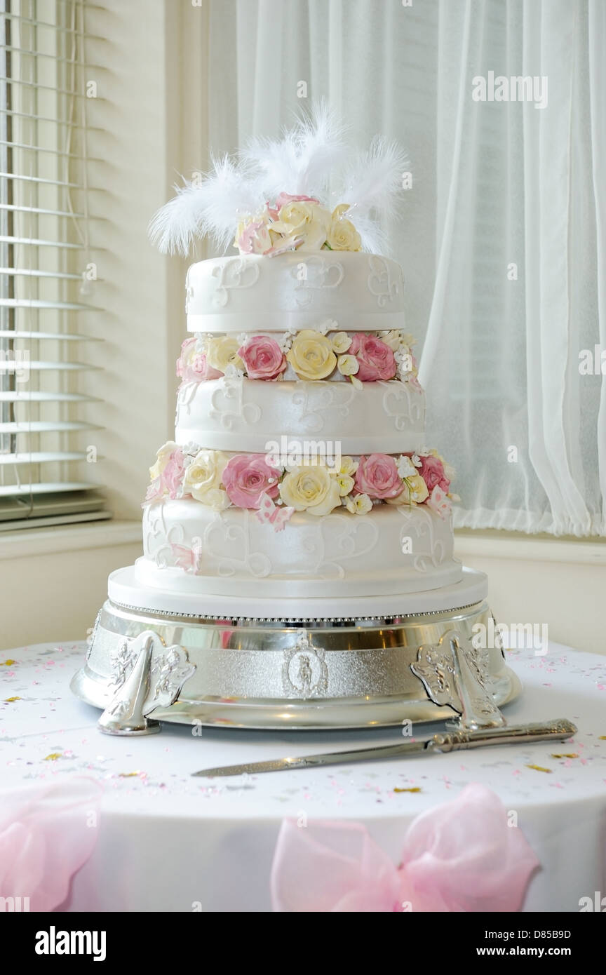 Wedding cake by window at reception Stock Photo - Alamy