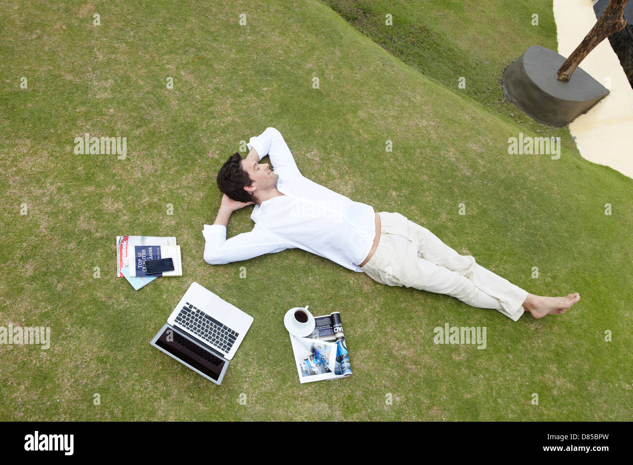 man lying on his back his hands behind his head Stock Photo - Alamy