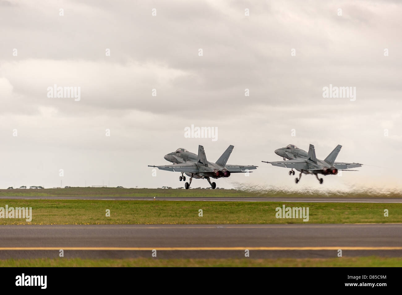 Two F/A-18 Hornet fighter jets go through their paces at an air show in ...