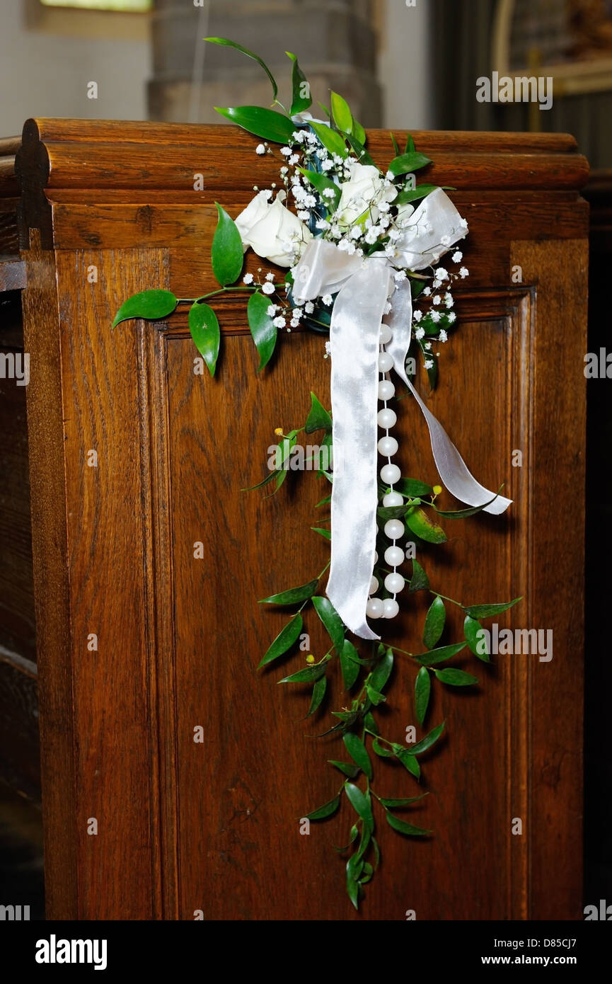 White roses decorate inside of church on wedding day Stock Photo - Alamy