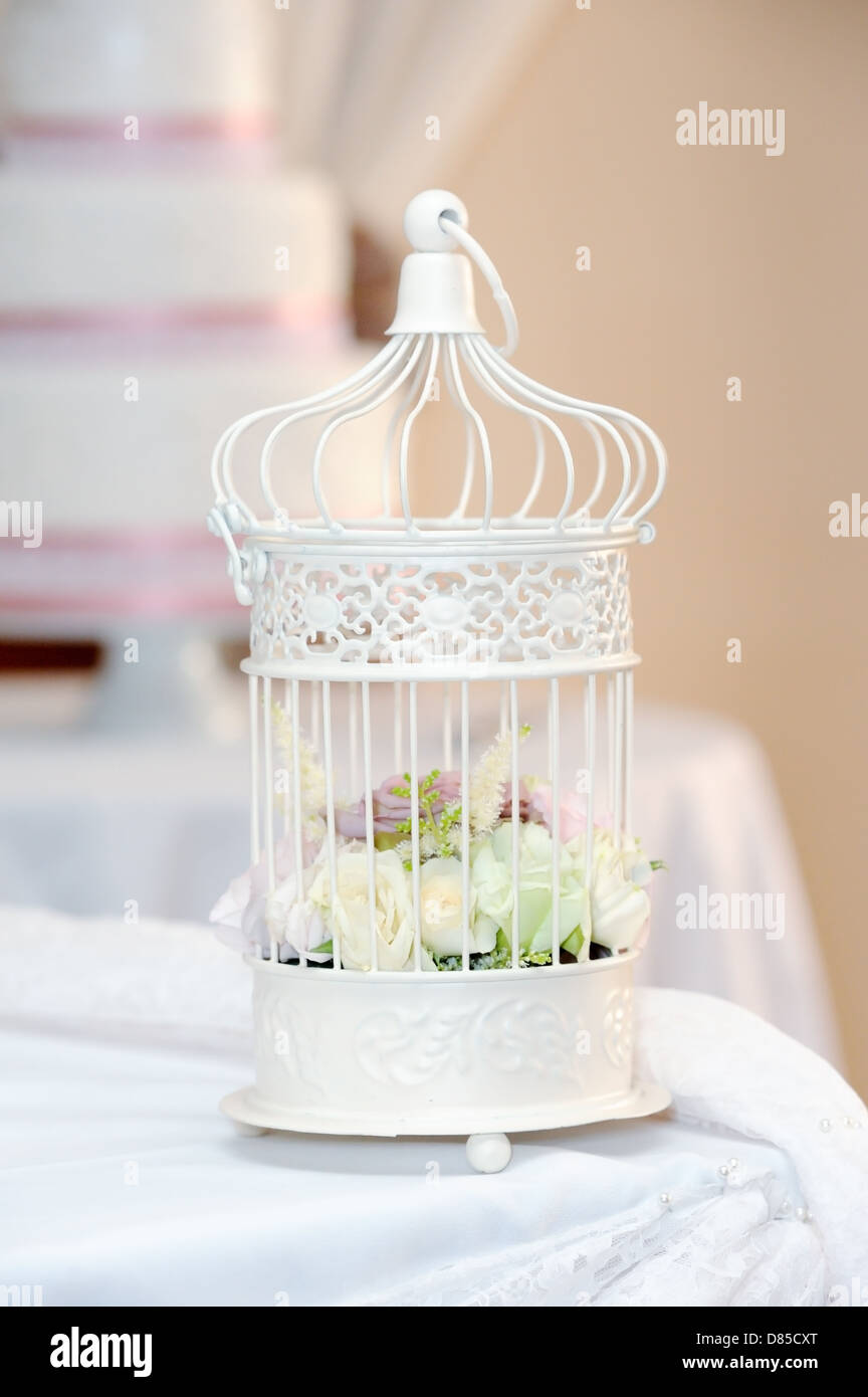 White cage with roses decorates a wedding reception Stock Photo - Alamy