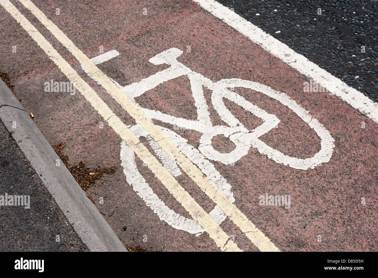 A cycle lane at the side of a road with cycling sign Stock Photo - Alamy