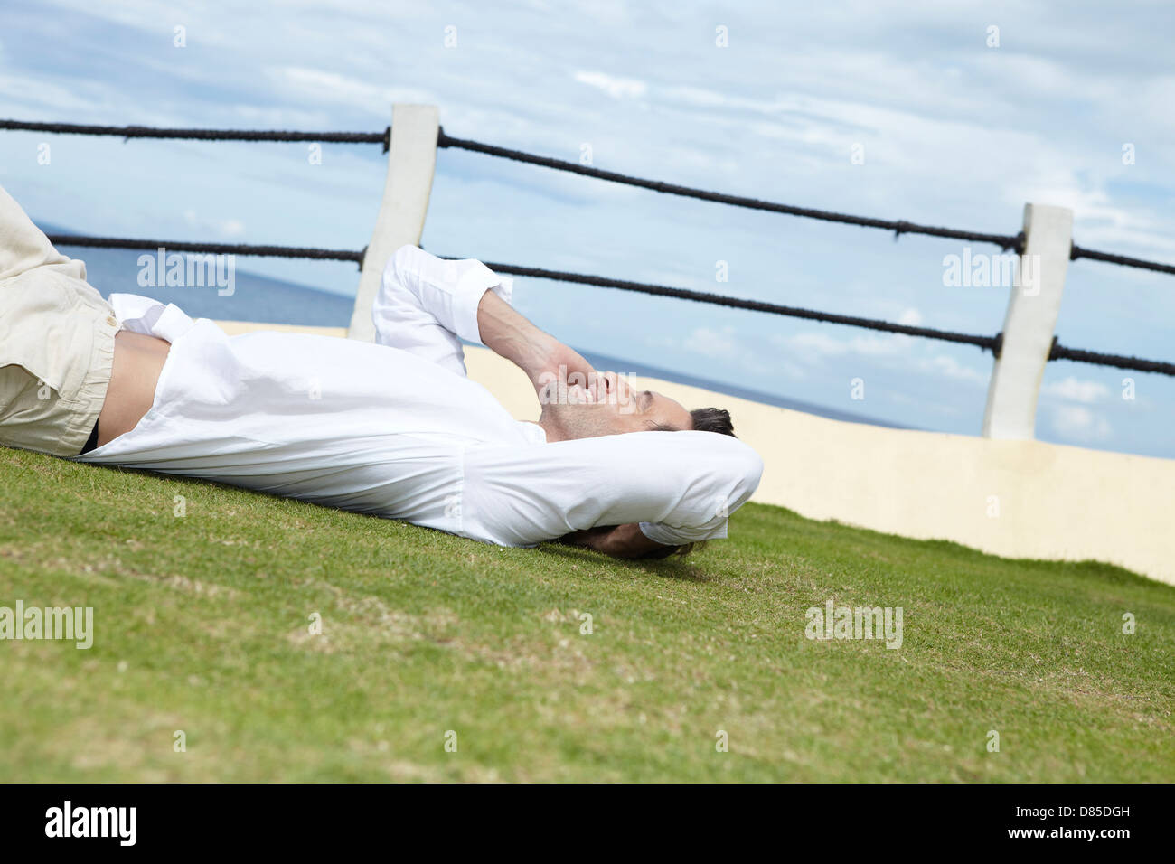 man lying on his back talking on mobile phone Stock Photo - Alamy