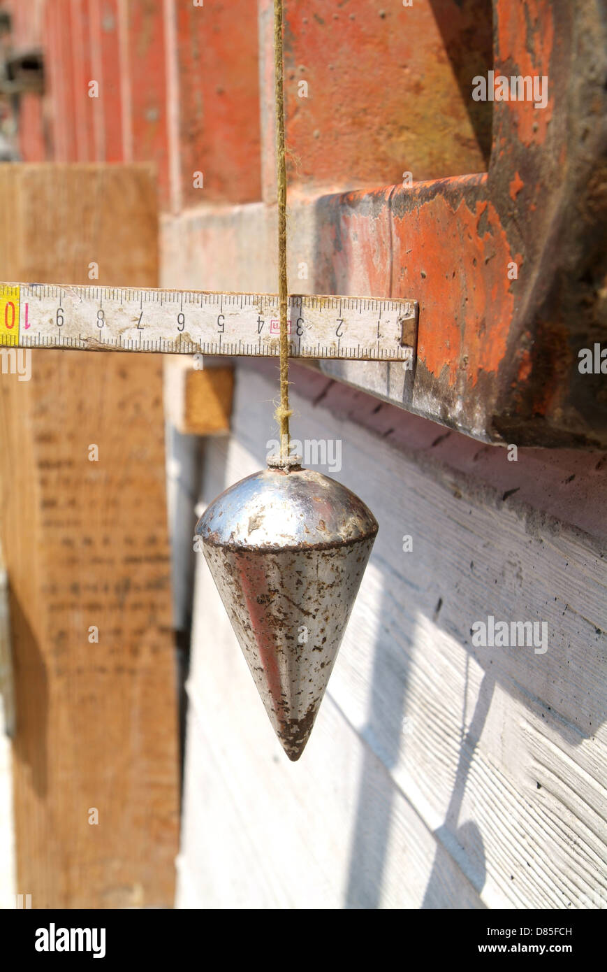 Pendulum for levell of construction Stock Photo - Alamy