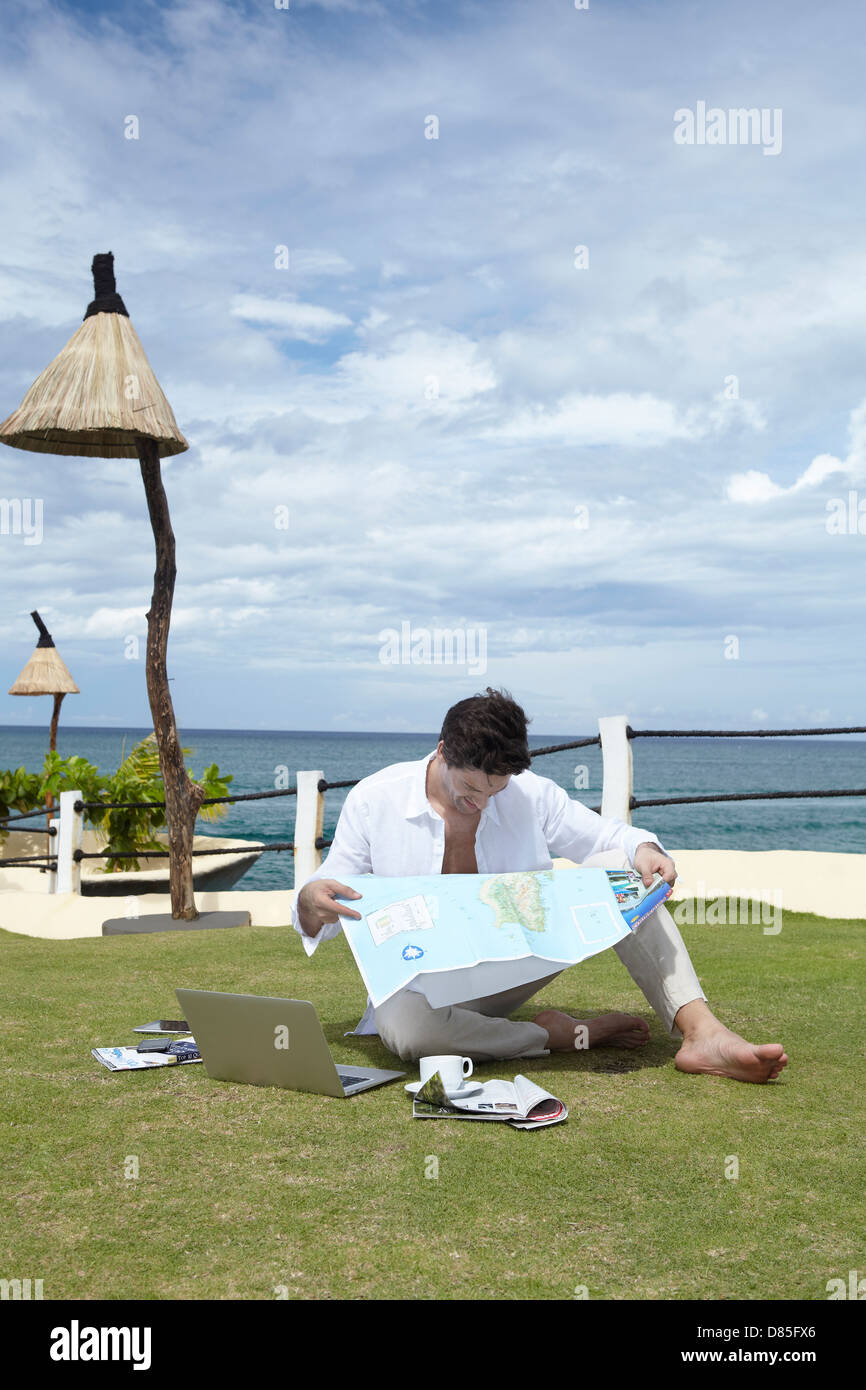 White Man Sitting While Reading Map High Resolution Stock Photography ...