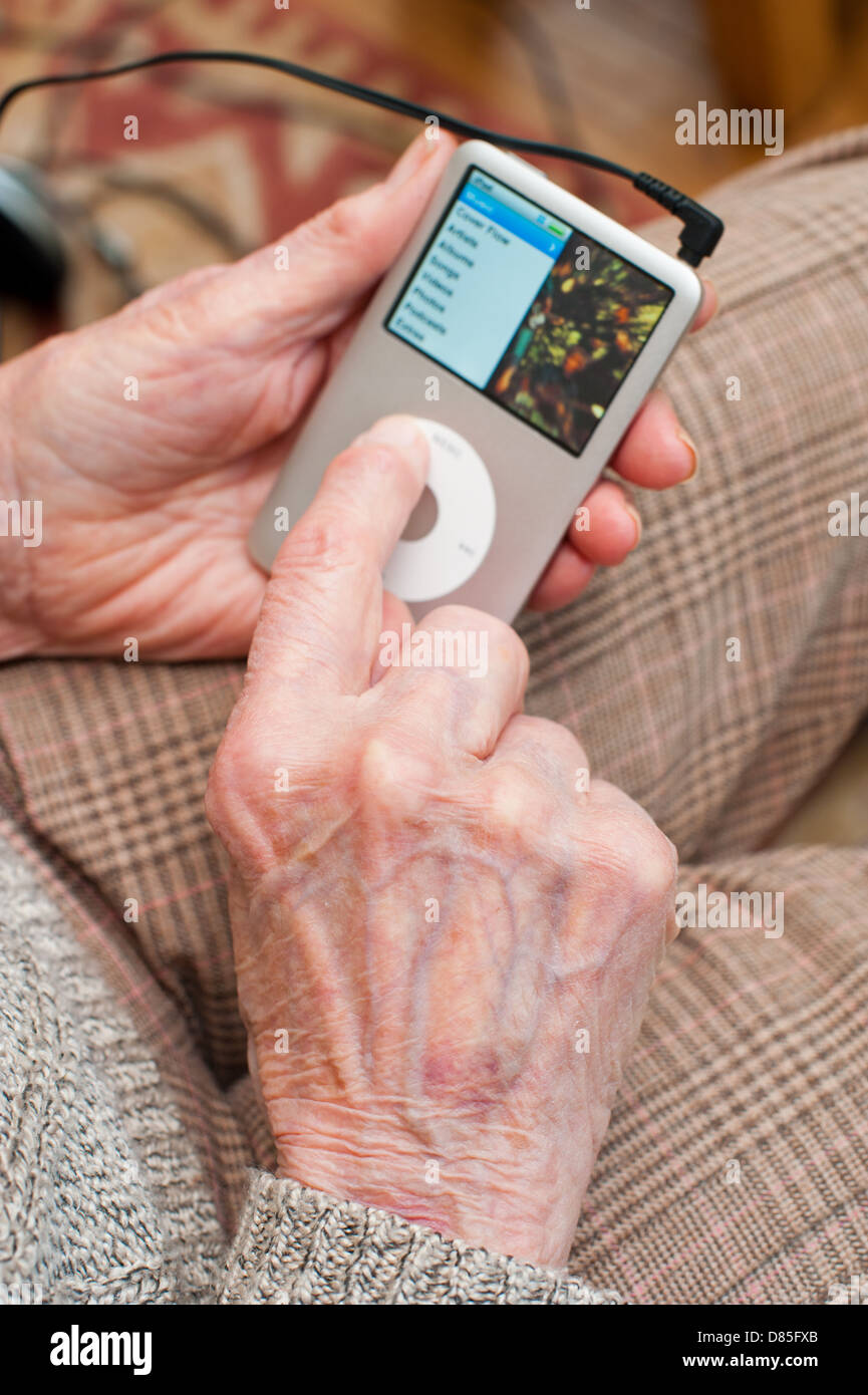 An elderly woman using an iPod Stock Photo - Alamy