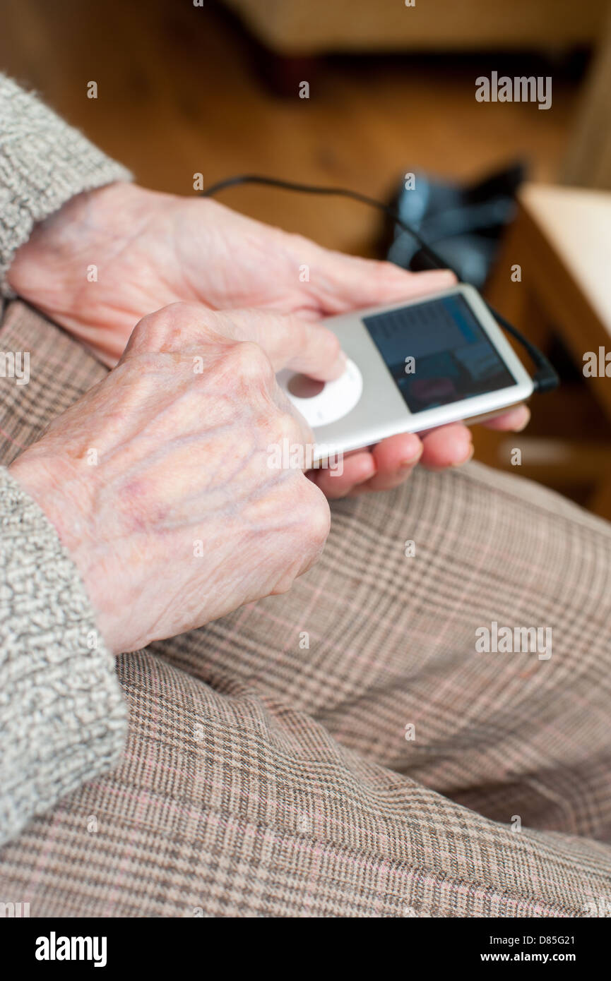 An elderly woman using an iPod Stock Photo - Alamy