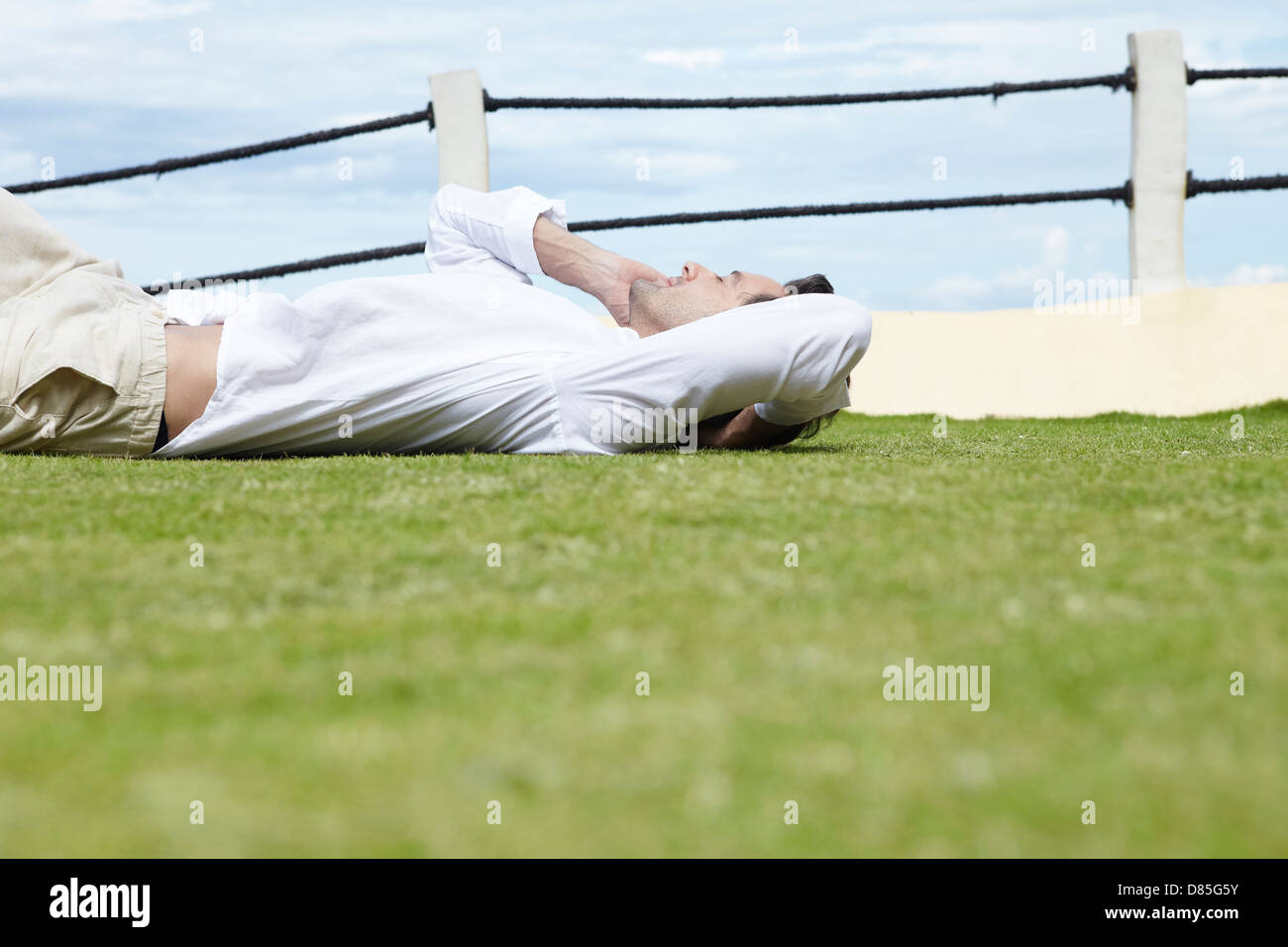 man lying on his back on grass Stock Photo - Alamy