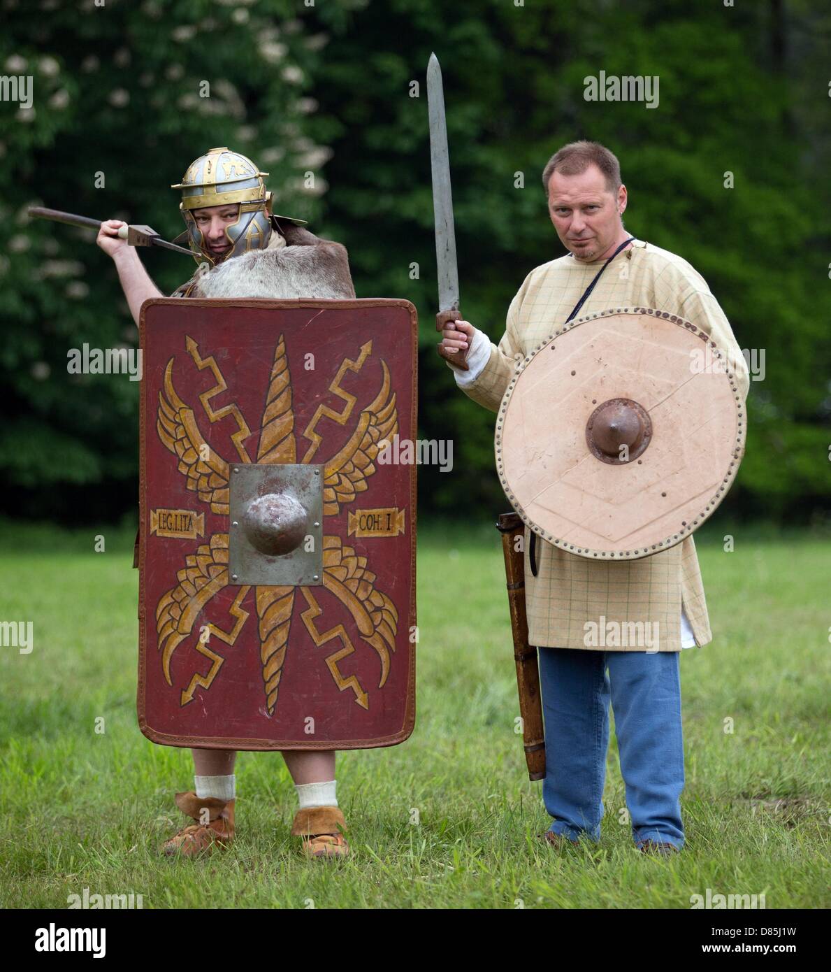 Performers in a Roman uniform (L) and Germanic garb stand next to each ...
