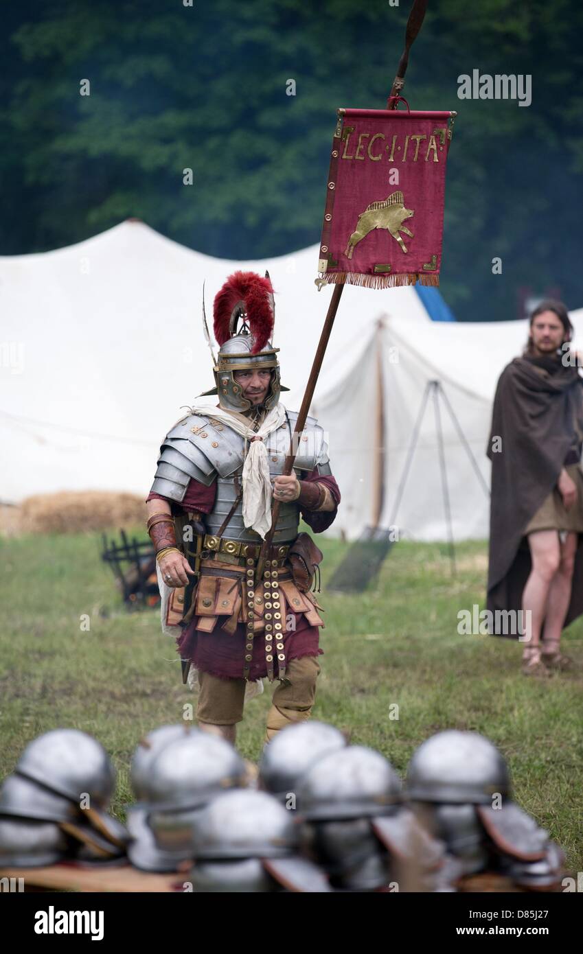 A performer in a Roman uniform carries a standard at The Battle of the ...
