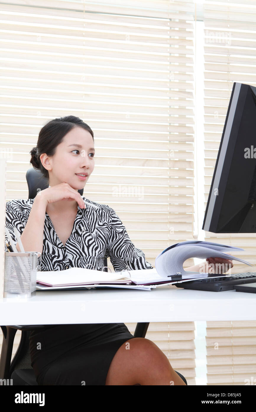 young woman sitting desk computer Stock Photo - Alamy