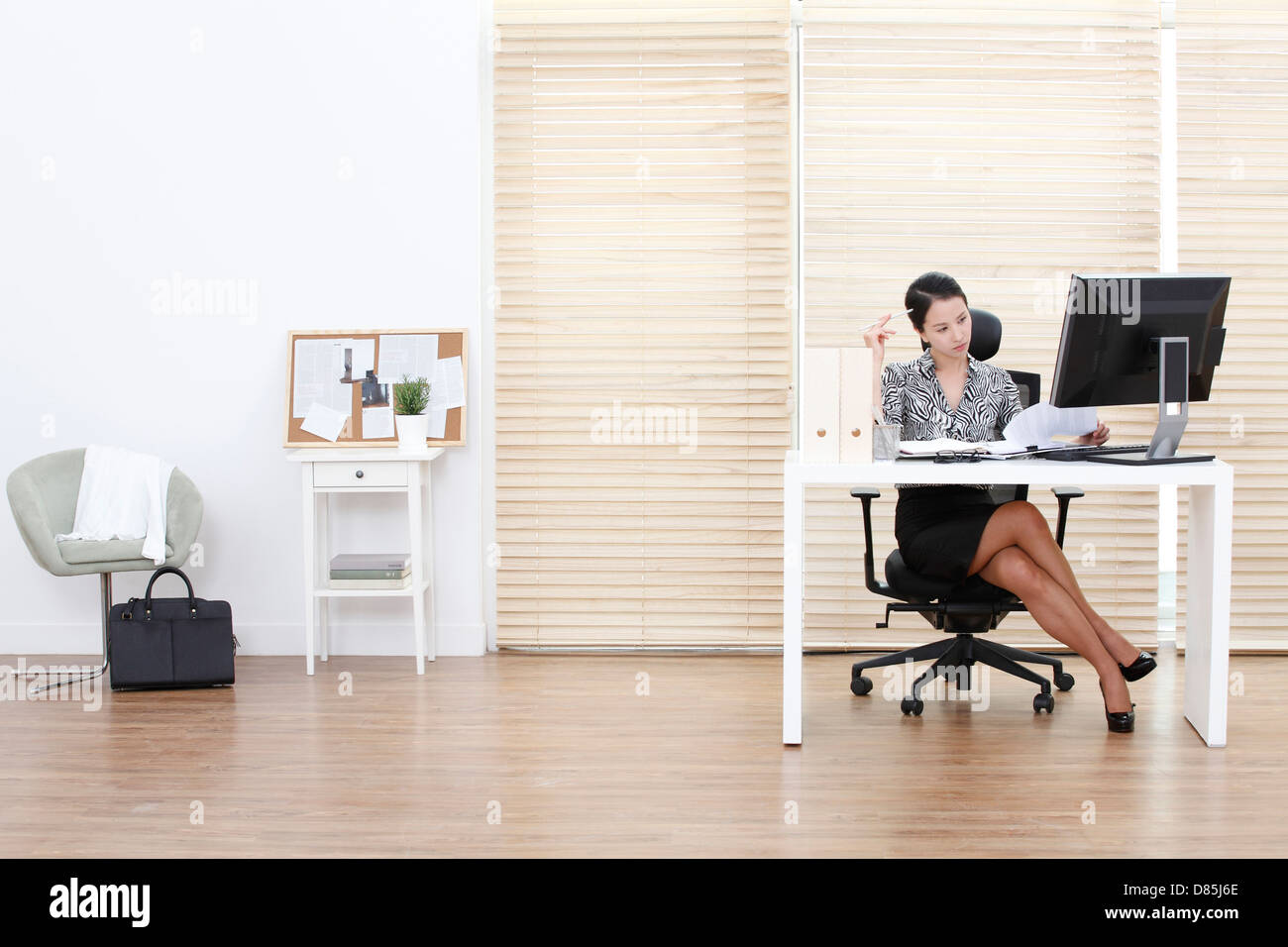 young woman sitting desk computer Stock Photo - Alamy