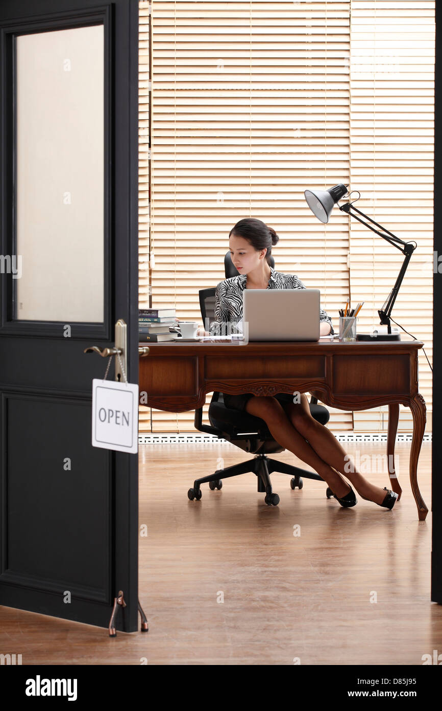 young woman sitting desk computer Stock Photo - Alamy