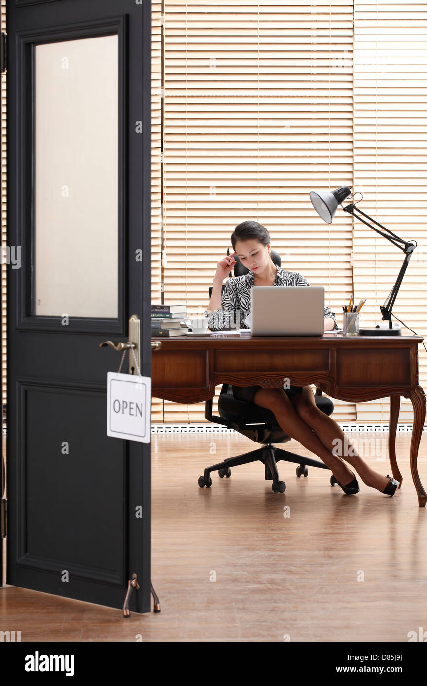 young woman sitting desk computer Stock Photo - Alamy
