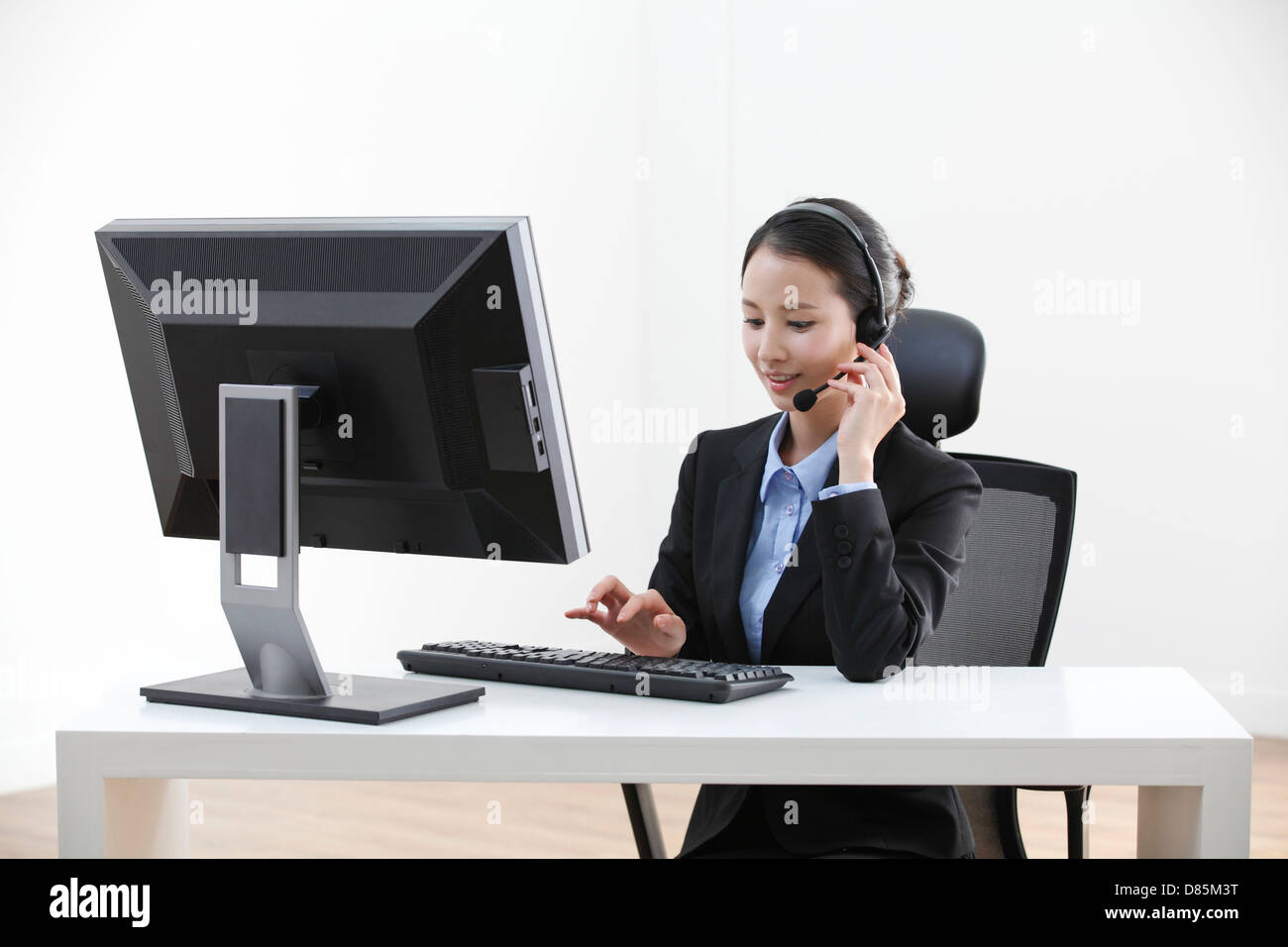 young woman sitting desk computer Stock Photo - Alamy