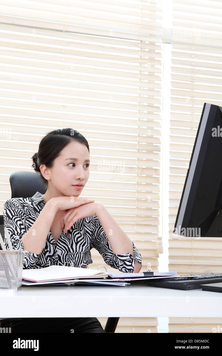 young woman sitting desk computer Stock Photo - Alamy