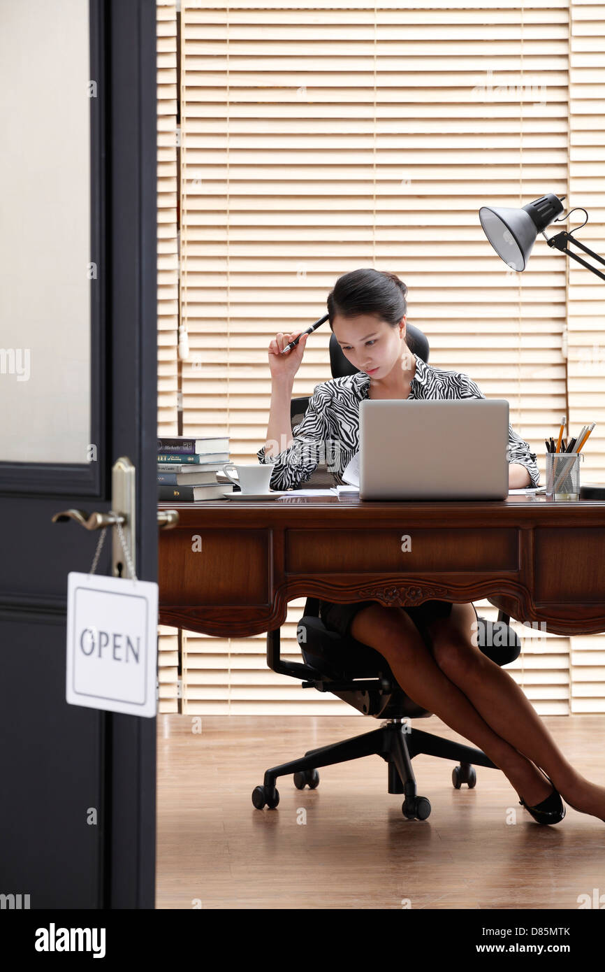 young woman sitting desk computer Stock Photo - Alamy