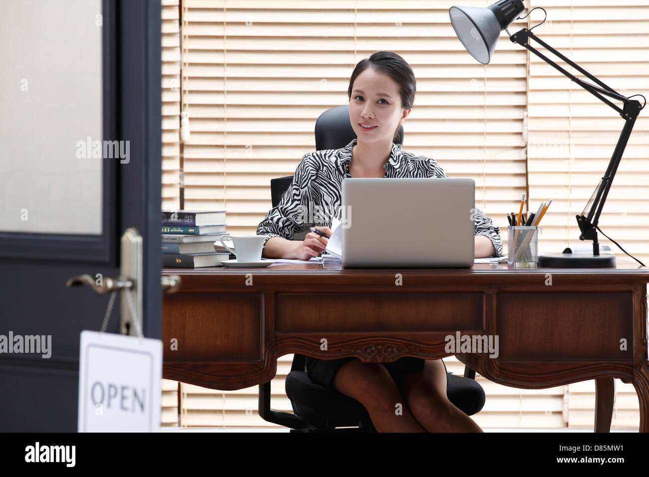 young woman sitting desk computer Stock Photo - Alamy