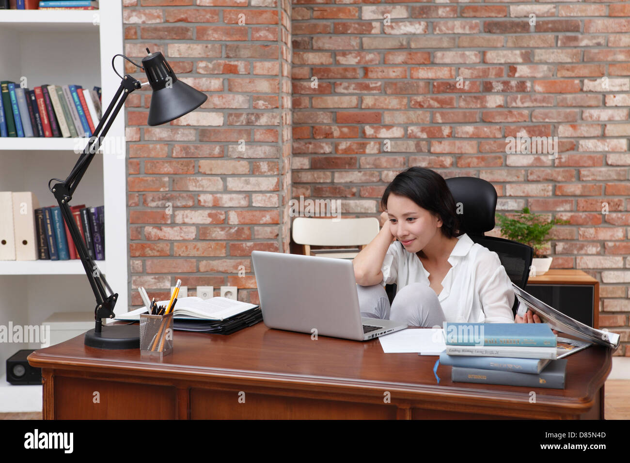young woman sitting desk computer Stock Photo - Alamy