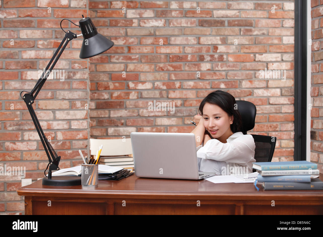young woman sitting desk computer Stock Photo - Alamy