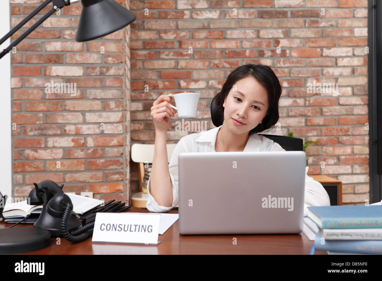 young woman sitting desk computer Stock Photo - Alamy
