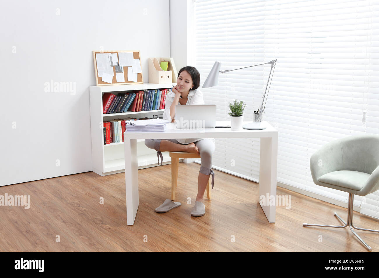 young woman sitting desk computer Stock Photo - Alamy